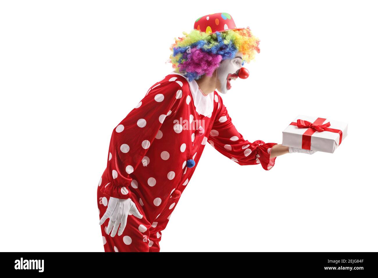 Clown giving a gift isolated on white background Stock Photo - Alamy