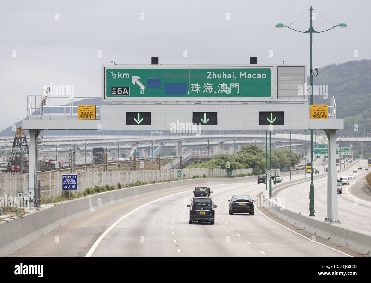 A road sign of Zhuhai, Macao direction seen on North Lantau Highway ...