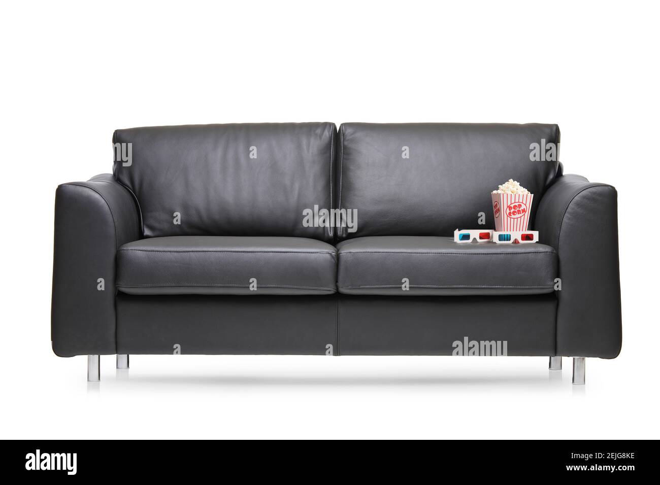 Black leather sofa with a box of popcorn and 3D glasses isolated on ...
