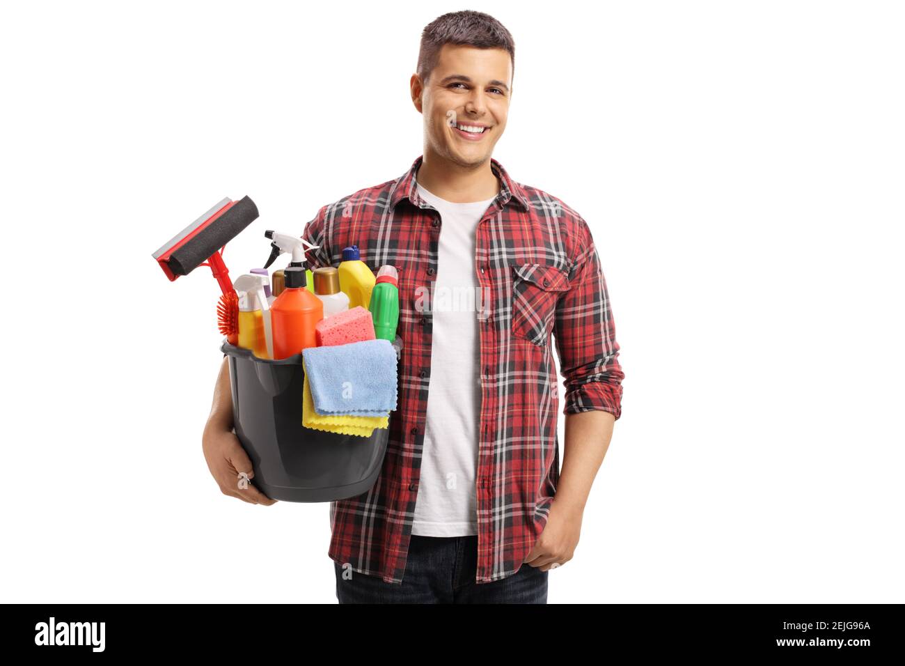 Young man smiling and holding a bucket full of cleaning supplies ...