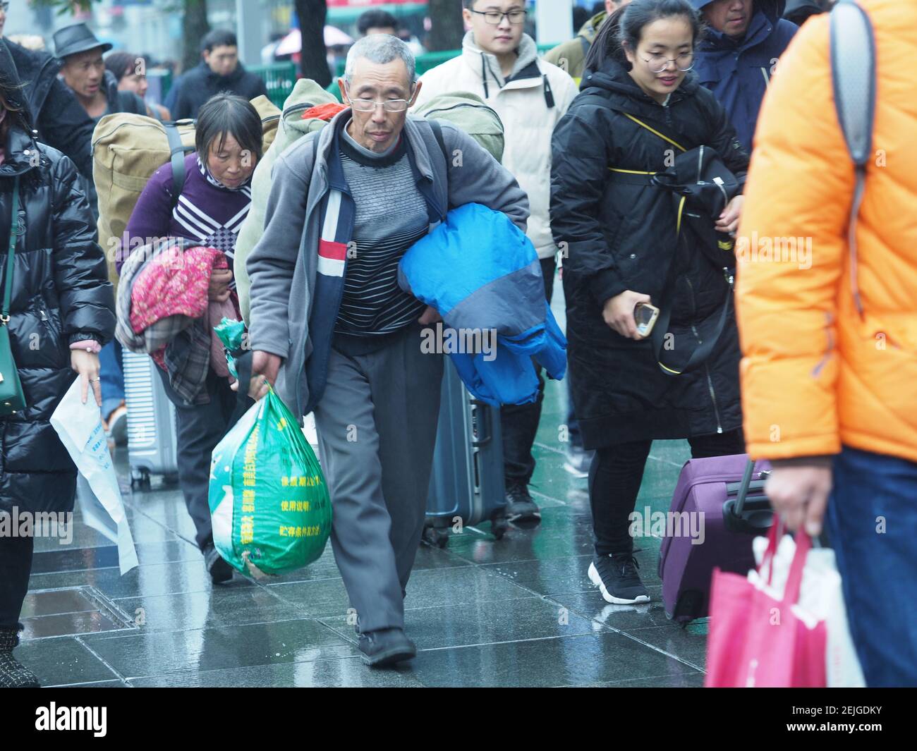 --File--Migrant workers carry luggages at the Shanghai New Bus Terminal ...