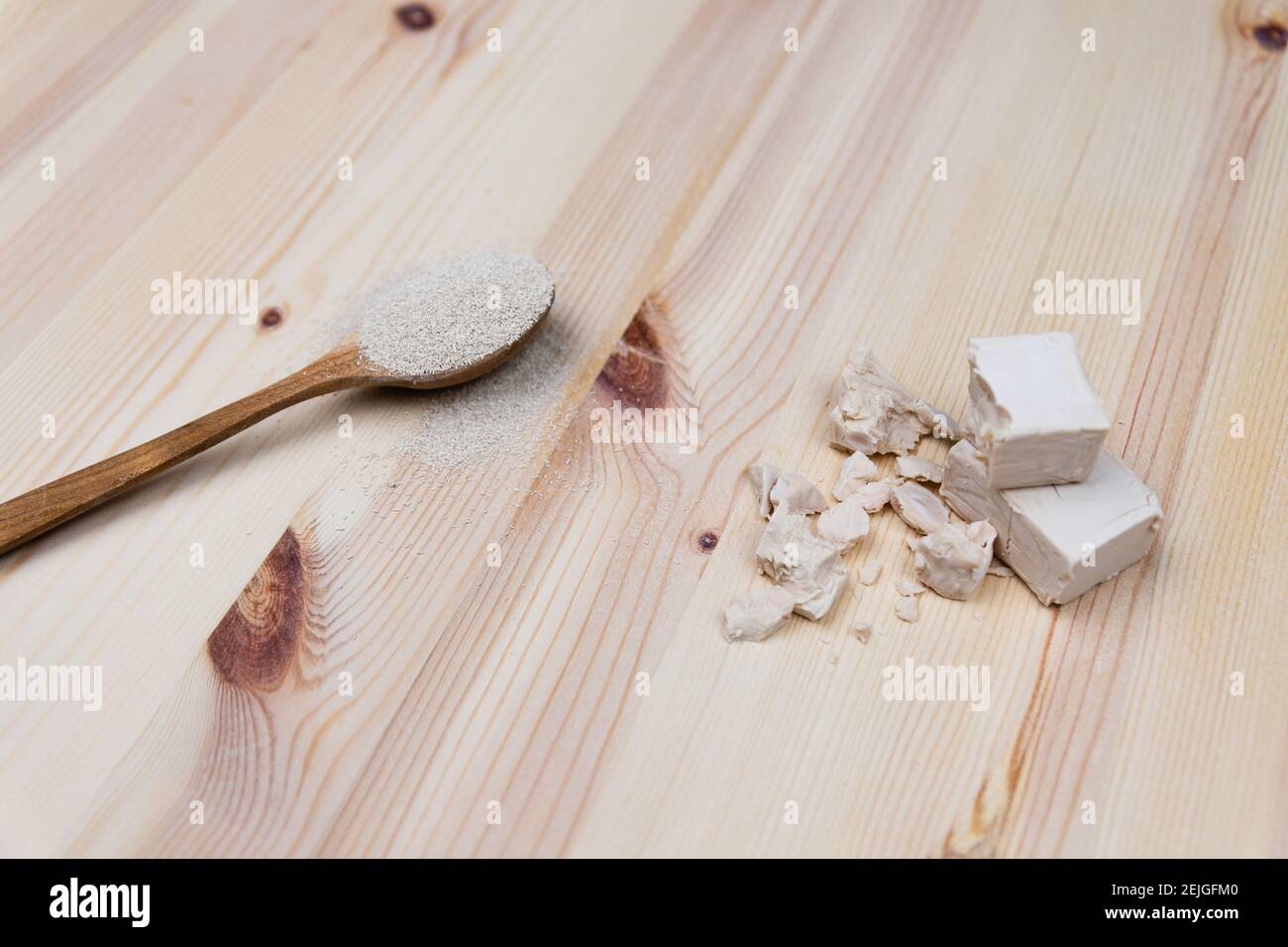Two different types of yeast on wooden background. Dry yeast in a ...