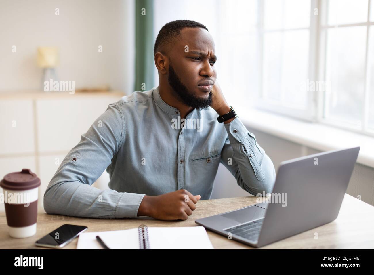 Bored Black Businessman Sitting At Laptop Working In Modern Office ...