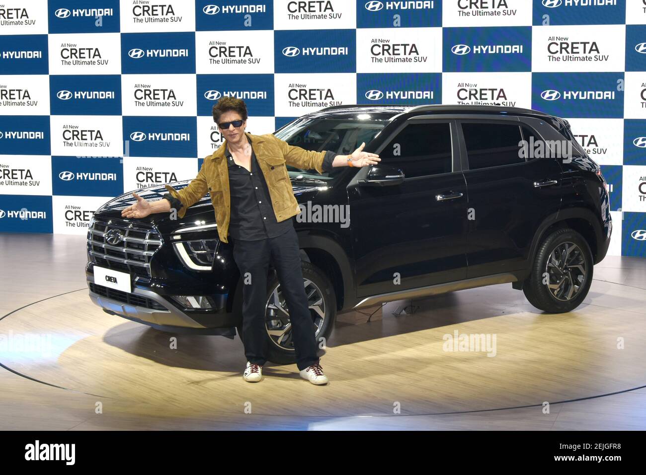 Indian Bollywood actor Shah Rukh Khan poses next to the newly launched Hyundai Creta SUV at the ...