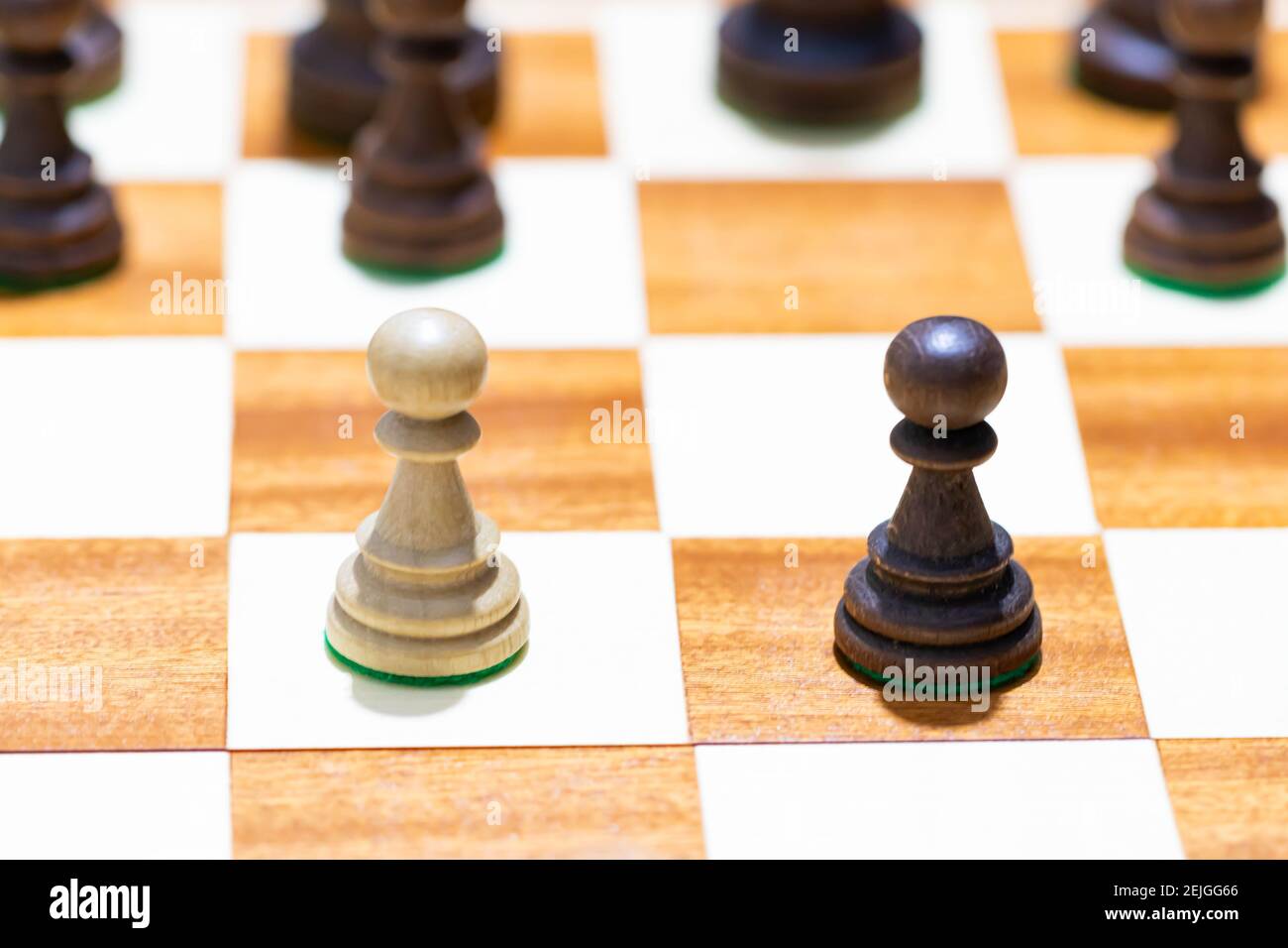 Playing wooden chess on a chessboard. Tactics and strategy. Black and ...
