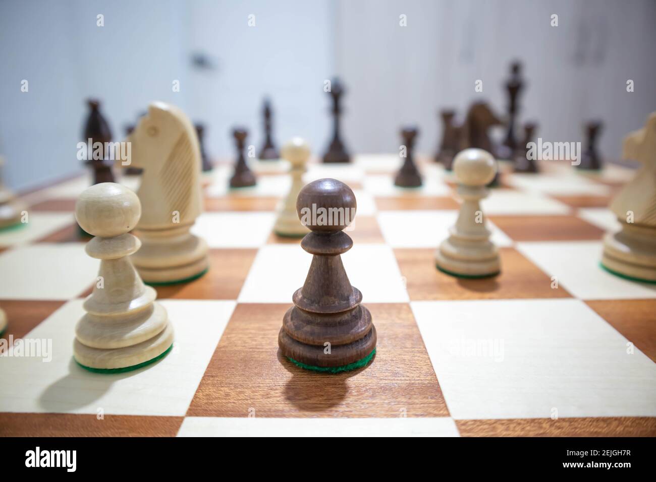 Playing wooden chess on a chessboard. Tactics and strategy. Black and white shapes Stock Photo ...