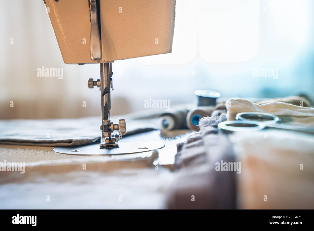 Sewing machine on a light background. Side view with copy space. The ...