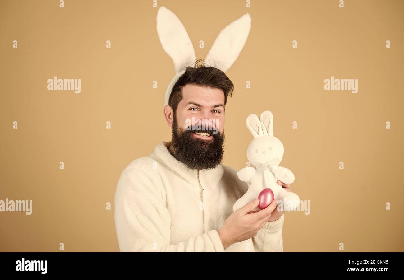 Man wearing rabbit suit play with toy. Funny bunny man soft ears ...