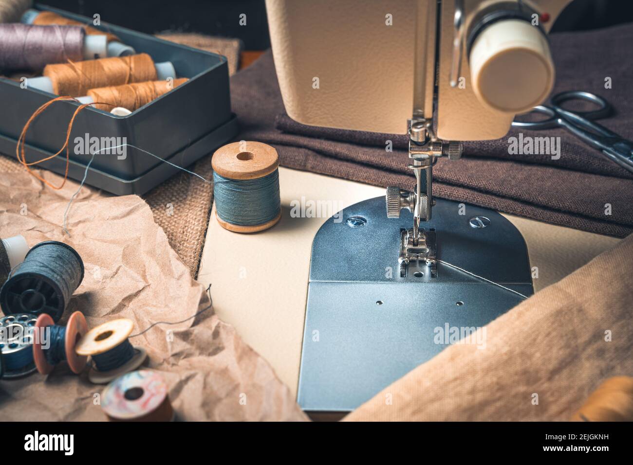 Sewing workplace with sewing machine and thread. Side view, close-up ...