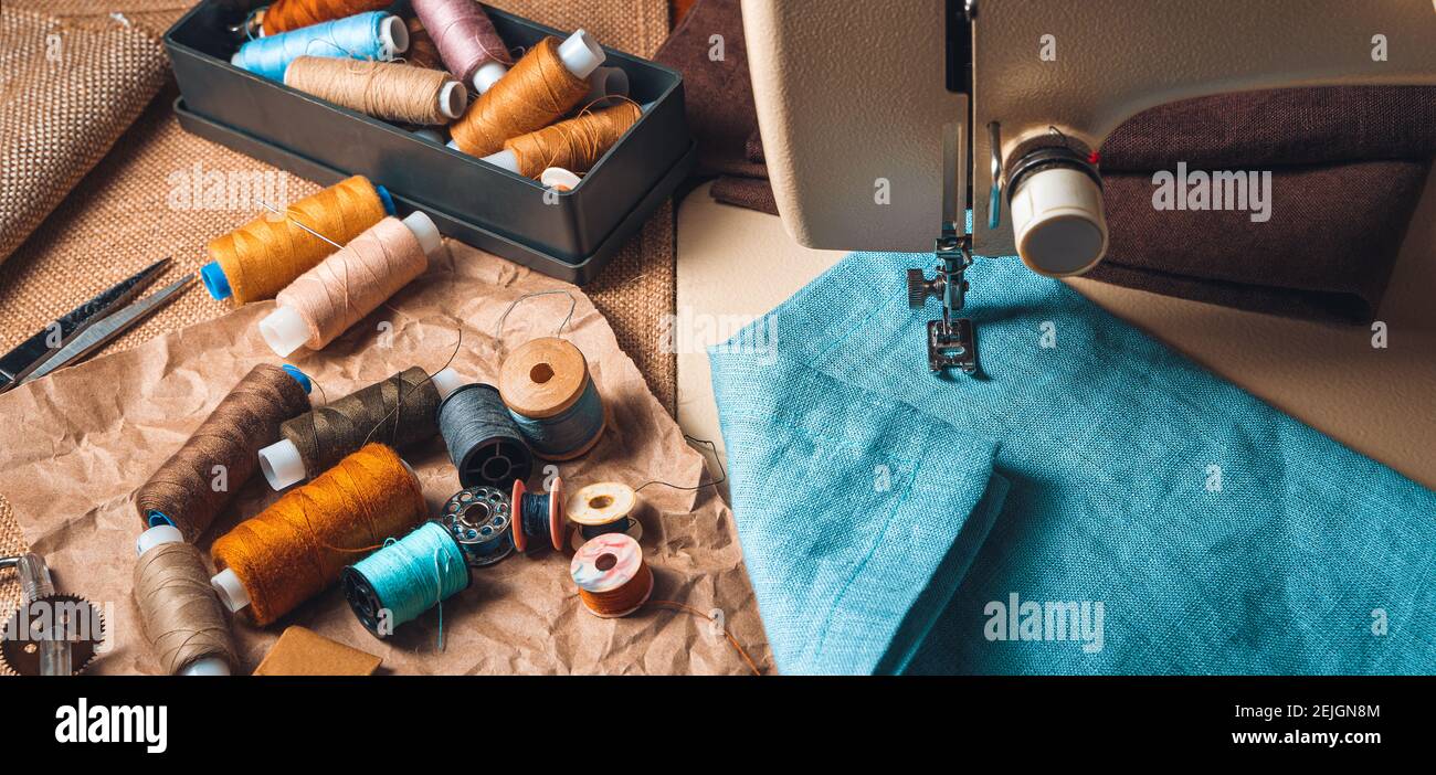 Vintage sewing background with threads and fabrics. Side view, panorama ...