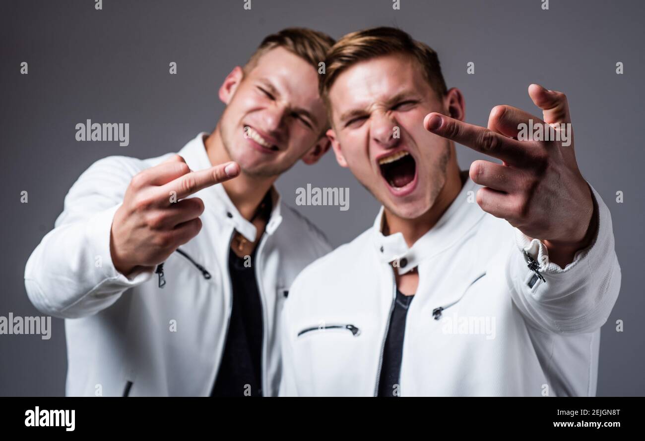 two cousin show middle finger. young confident brothers. confident ...
