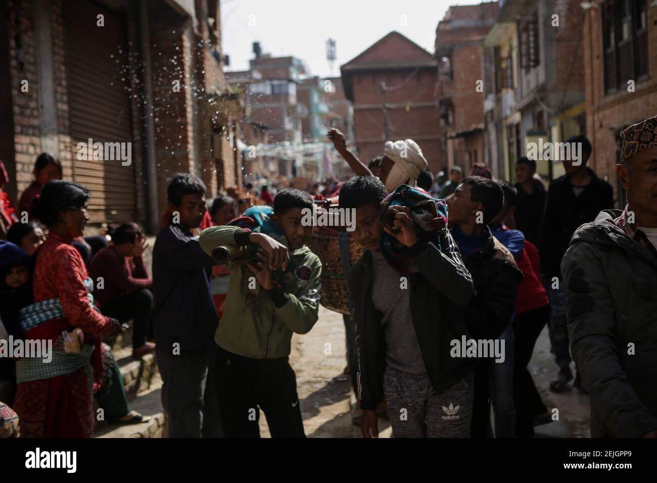 A devotee sprinkles holy water as he is carried in a vessel during the ...