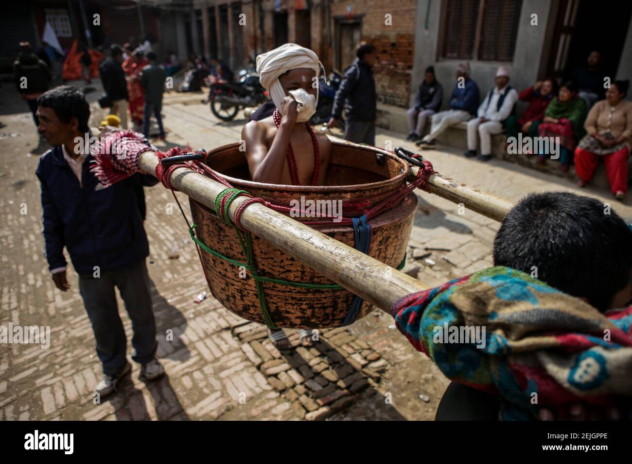 A devotee being carried in a vessel during the festival. The Madhav ...