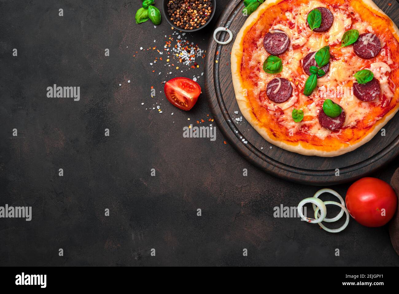 Culinary background with pepperoni pizza on a brown background with ...