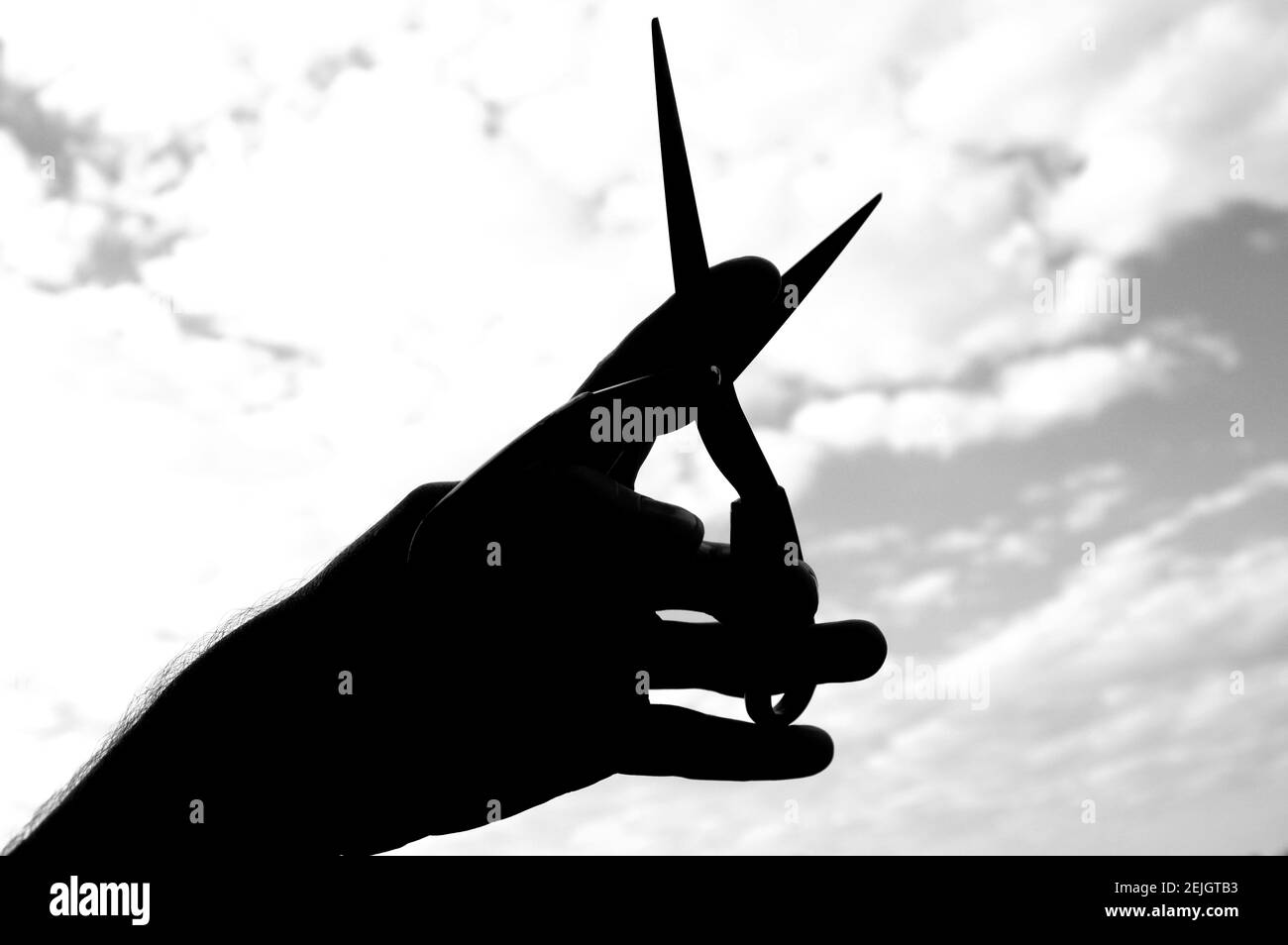 Hand holding opened scissor ready to cut Stock Photo - Alamy