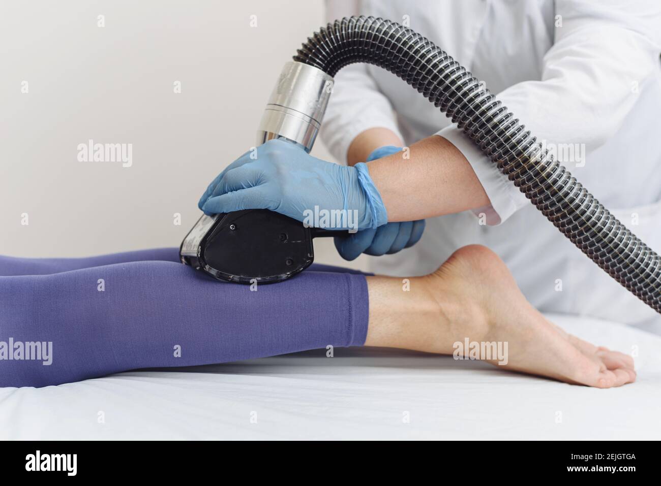 Young woman doing LPG leg procedure. Advertising. Lymphatic drainage ...