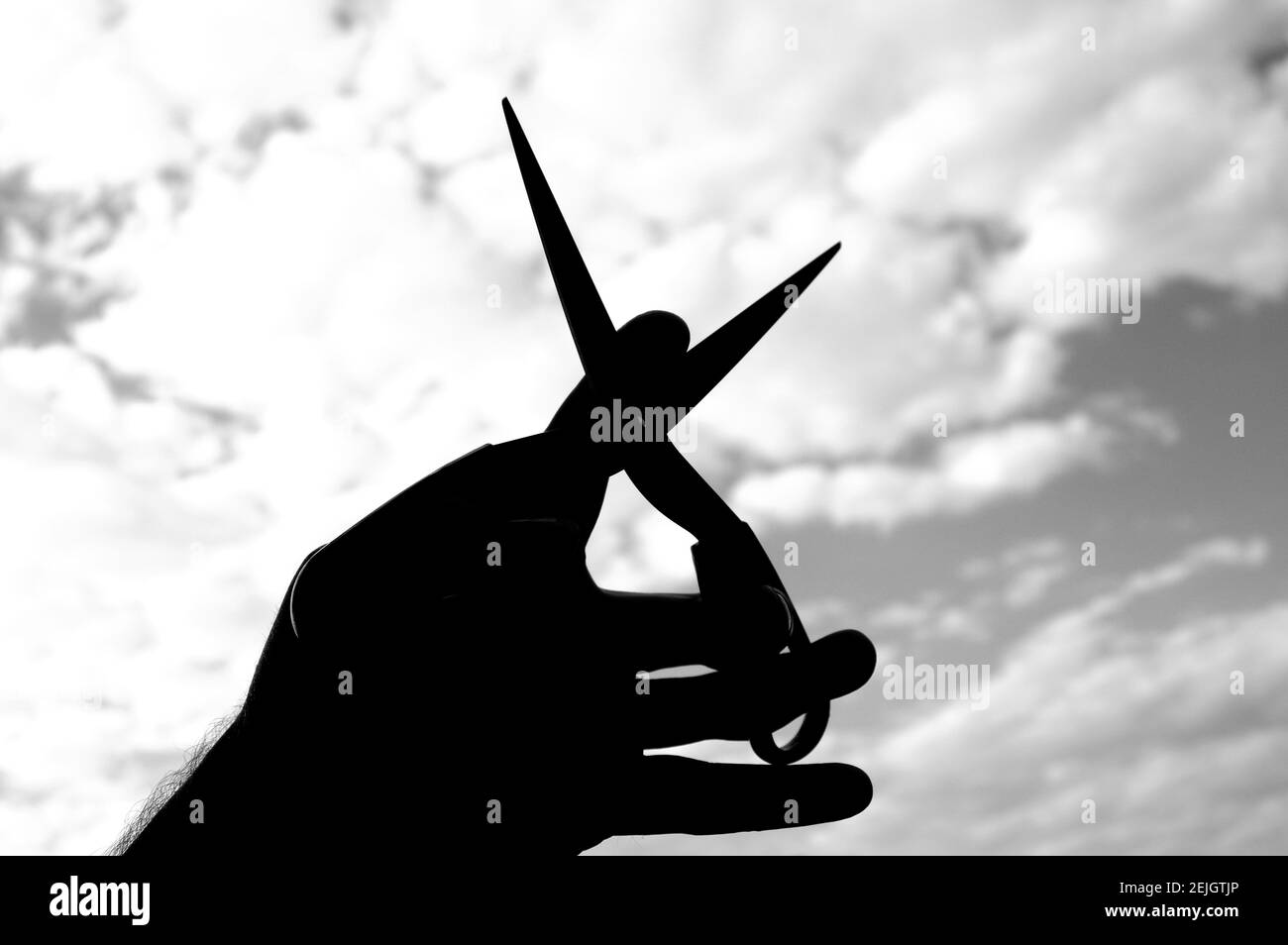 Hand holding opened scissor ready to cut Stock Photo - Alamy