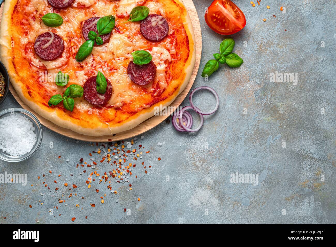 Cooking background with pizza and ingredients on a gray background ...