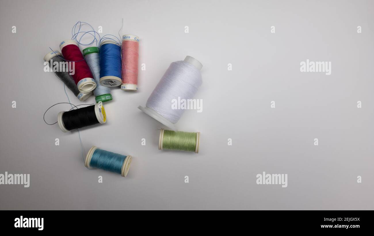 Overhead shot of rolls of thread for sewing with various colors and ...
