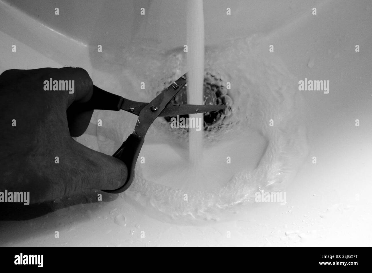 Hand holding opened scissor ready to cut Stock Photo - Alamy