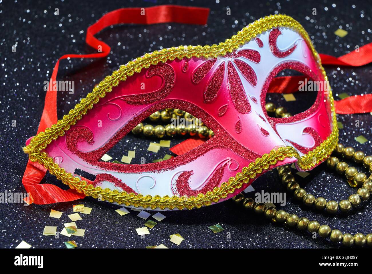 Red Carnival Mask With Gold Beads And Confetti Stock Photo - Alamy