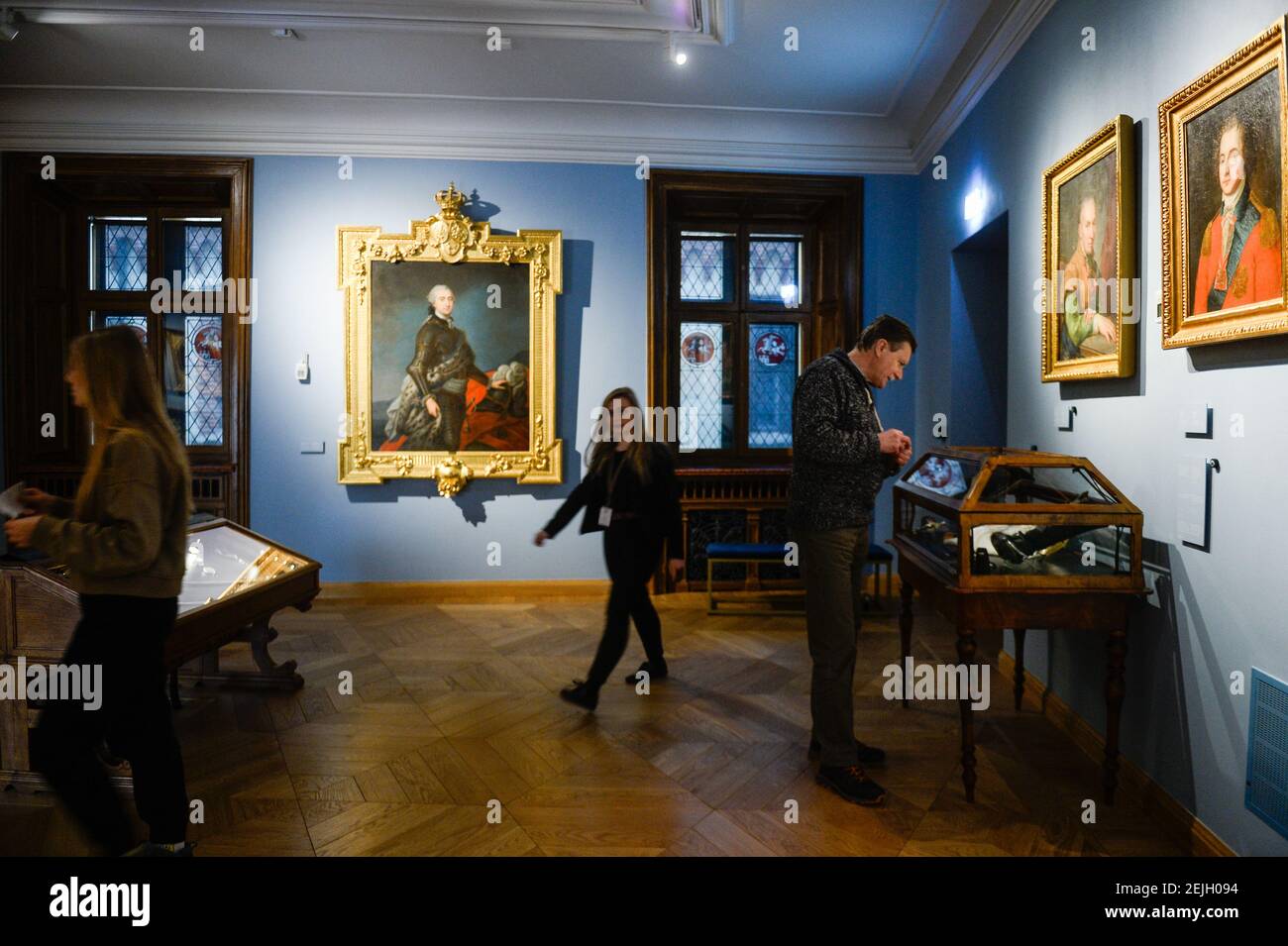A visitor admires religious paintings at a recently opened Palace of ...