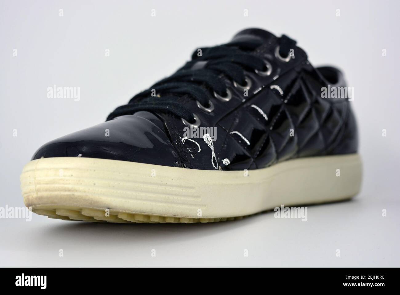 Stylish bright black lacquer shoes located on a white background ...