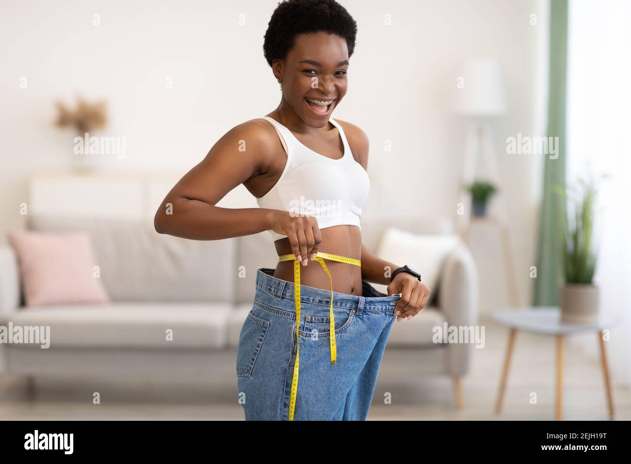 Fit african woman tape measure hi-res stock photography and images - Alamy