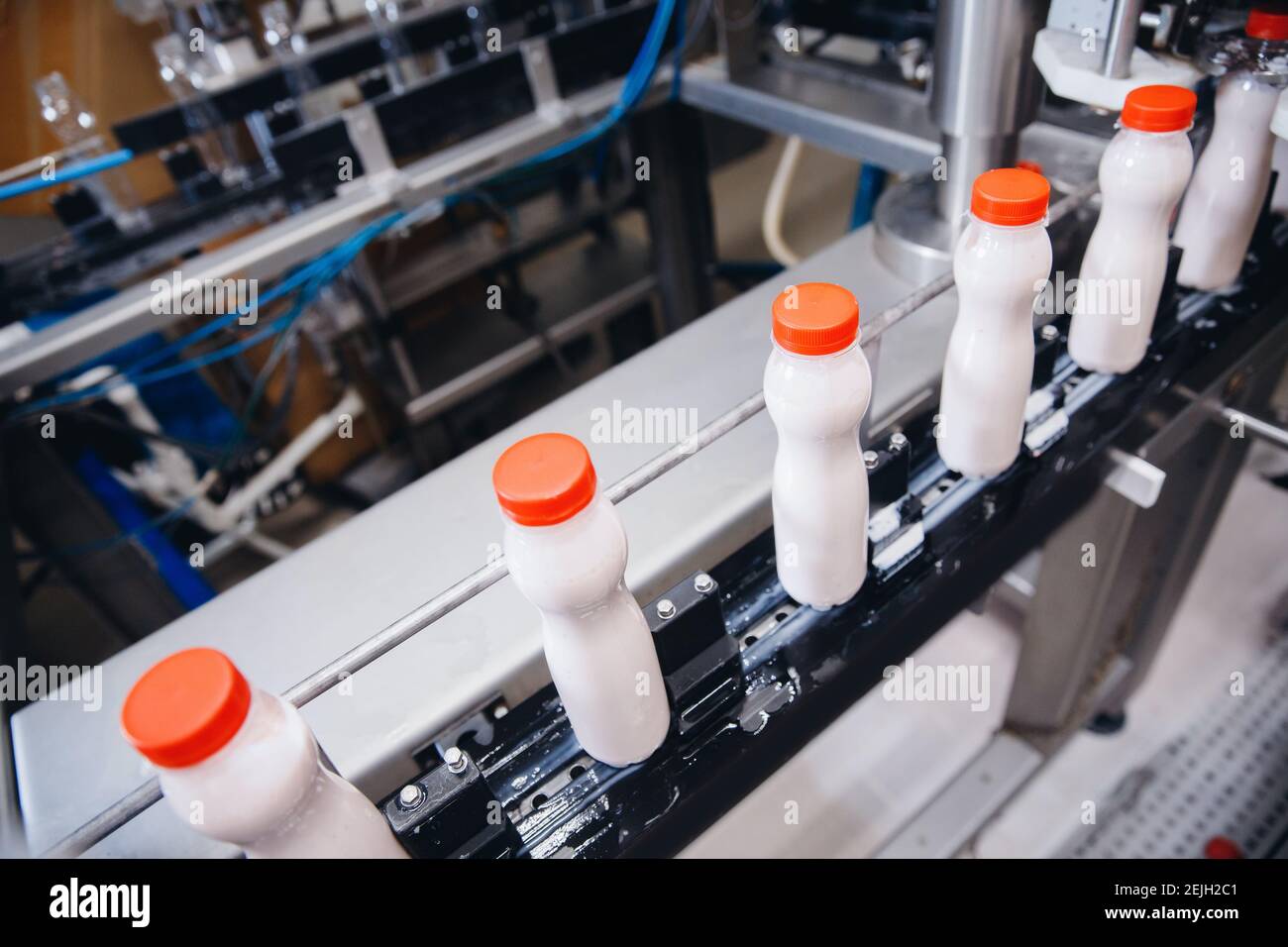 Dairy production, bottle of yoghurt on automated conveyor line, process ...