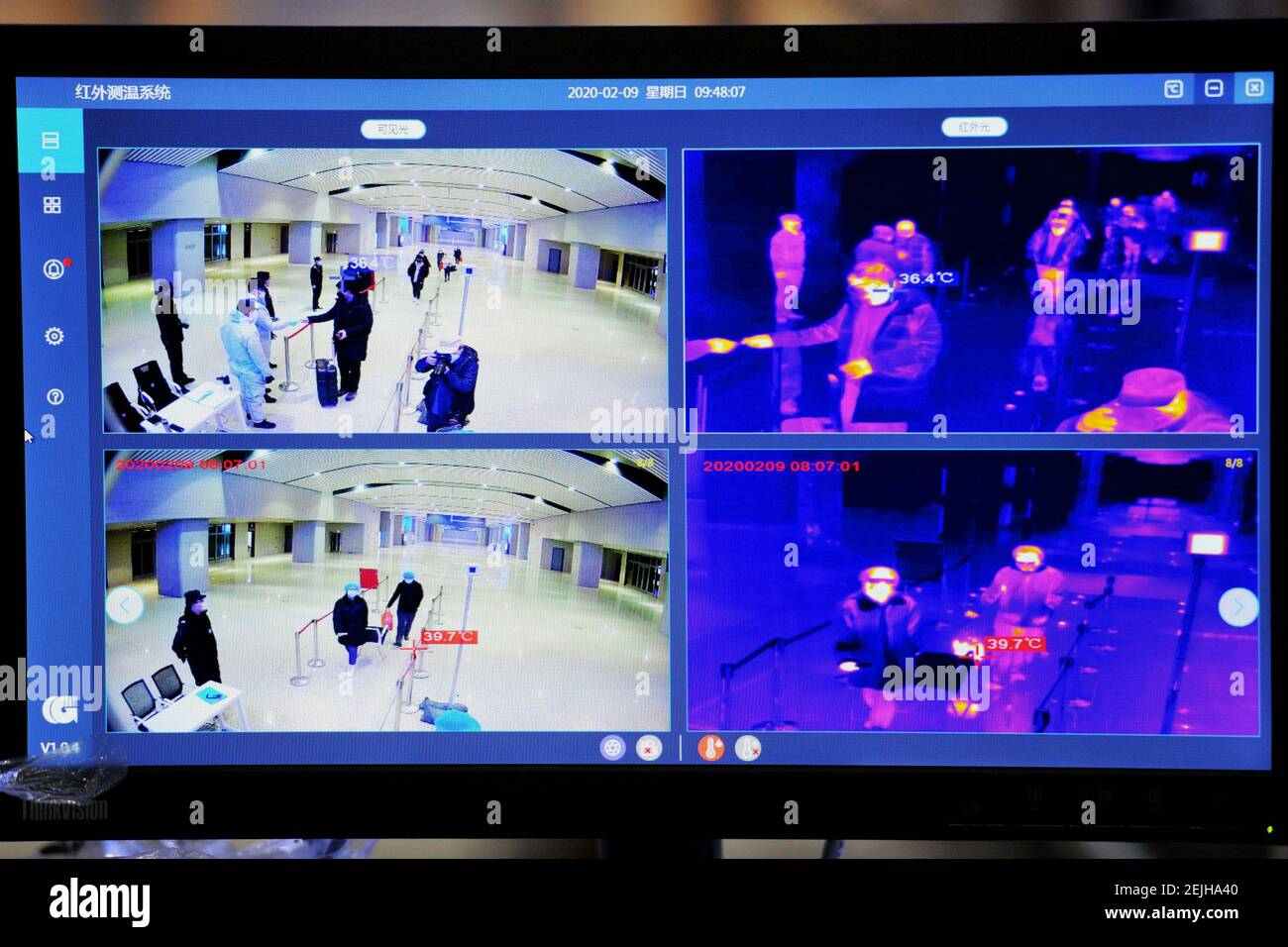 A display shows that passengers' body temperatures are monitored for ...