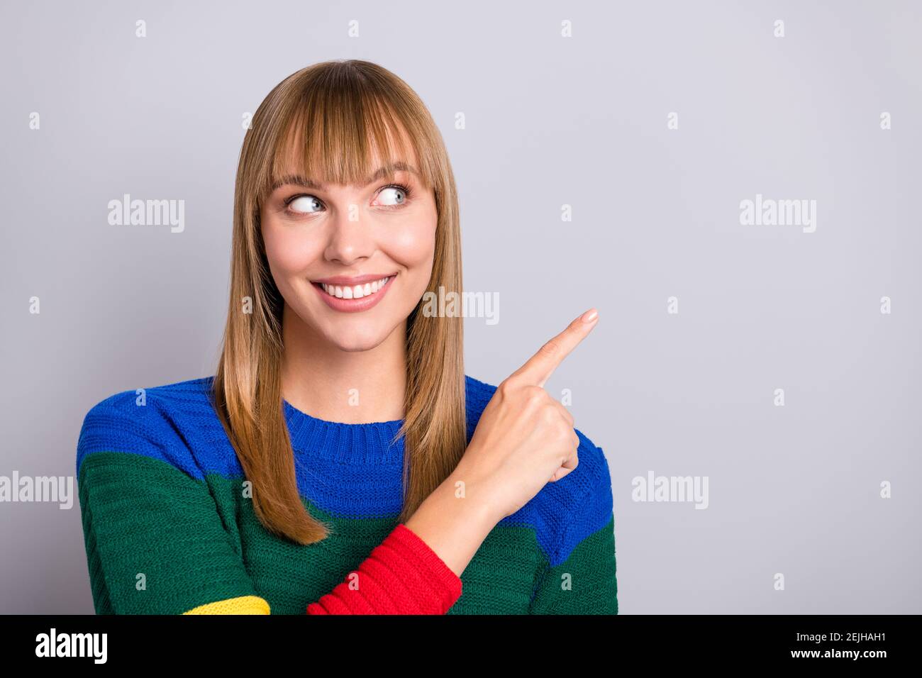 Photo portrait of dreamy girl showing finger at copyspace smiling ...