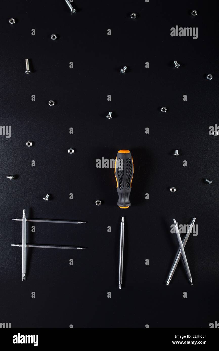 Word FIX from Elecrtonic repair tools and bolts and nuts on black ...