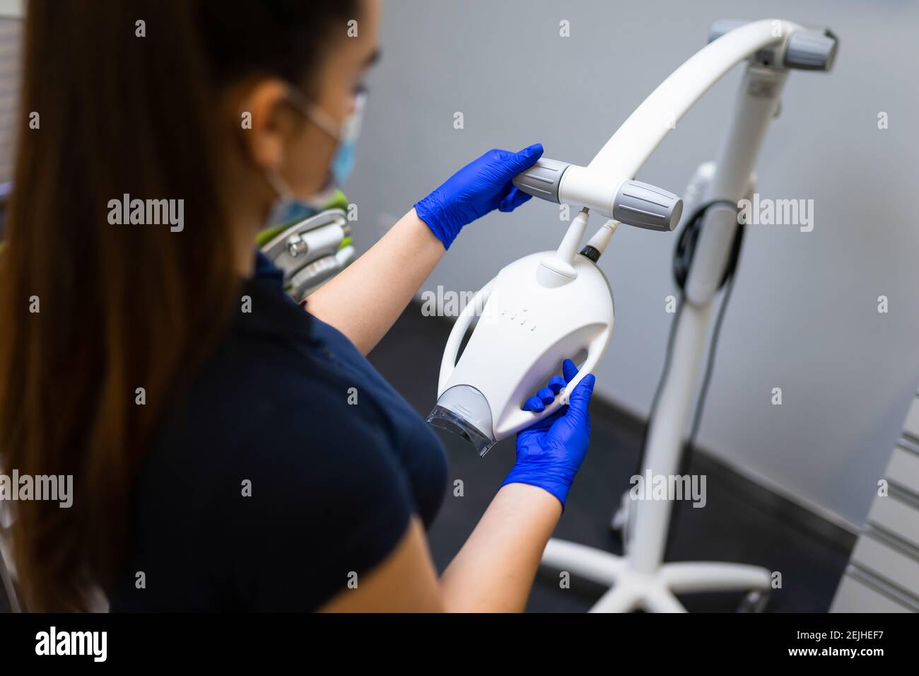 Dentist with teeth whitening machine Stock Photo - Alamy