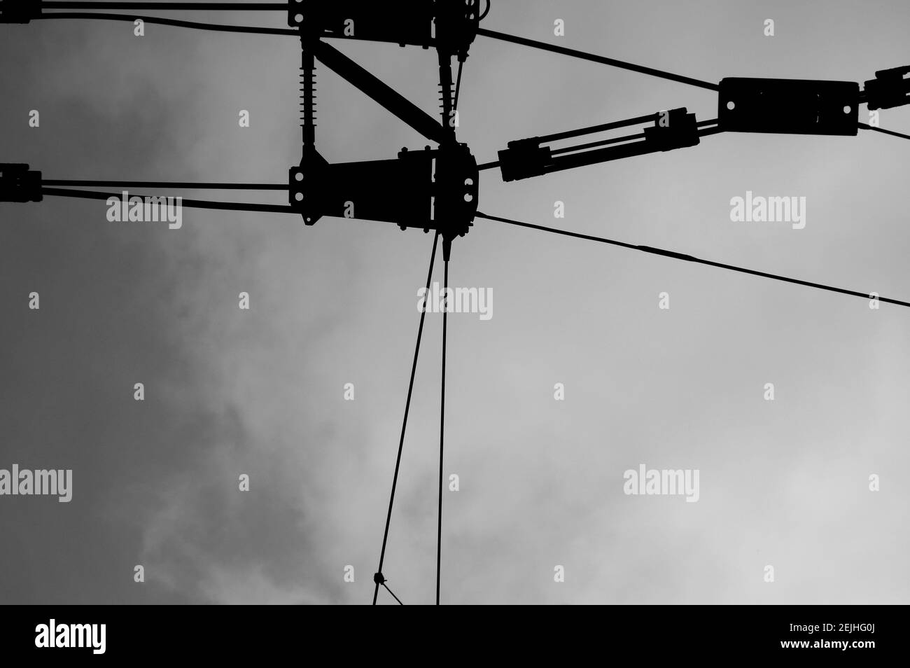 Tram sectional insulator against the sky with a connected supply wire ...