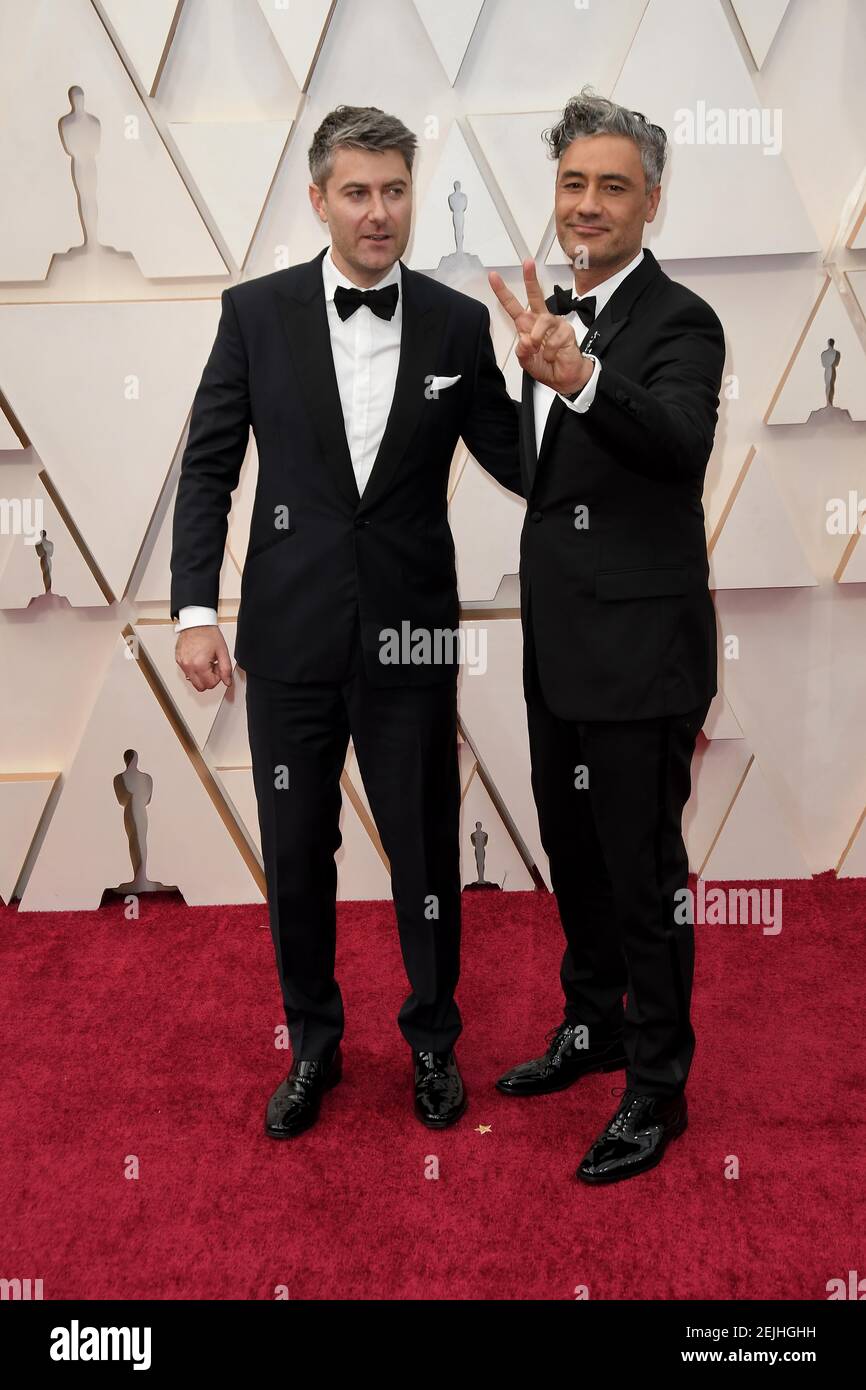 Carthew Neal and Taika Waititi walking on the red carpet at the 92nd ...