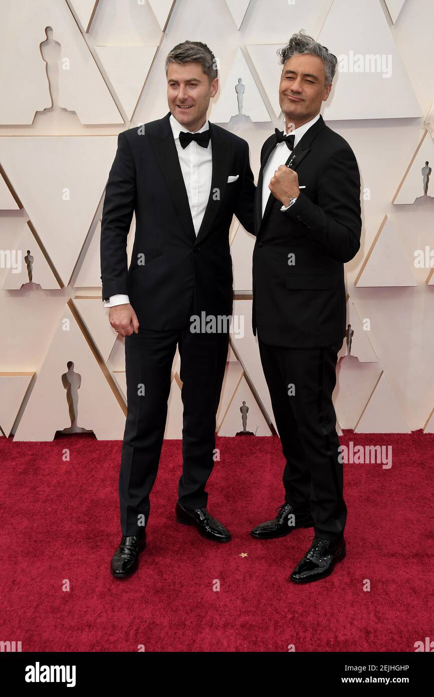 Carthew Neal and Taika Waititi walking on the red carpet at the 92nd ...