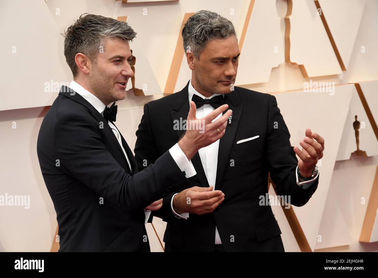 Carthew Neal and Taika Waititi walking on the red carpet at the 92nd ...