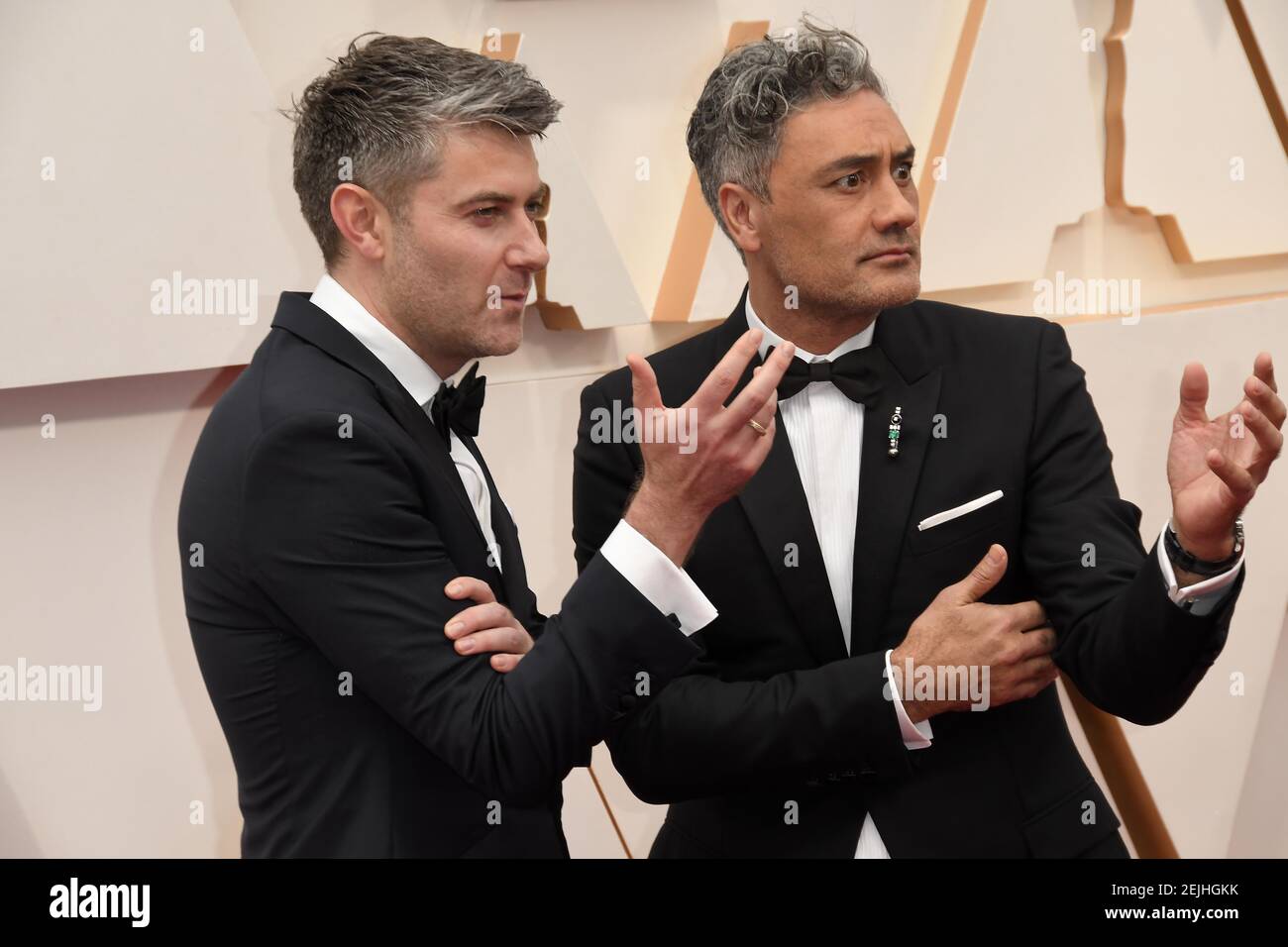 Carthew Neal and Taika Waititi walking on the red carpet at the 92nd ...