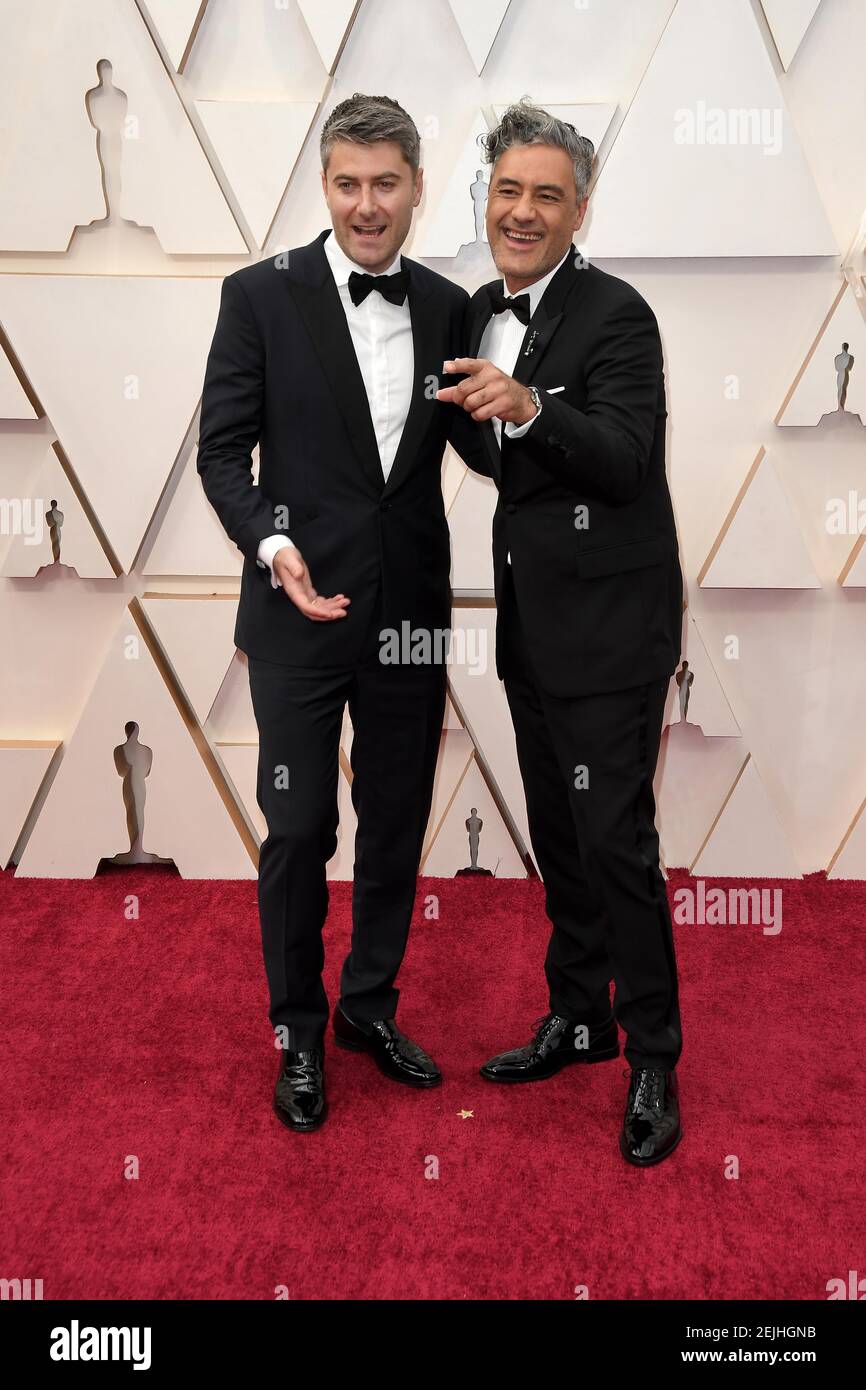 Carthew Neal and Taika Waititi walking on the red carpet at the 92nd ...