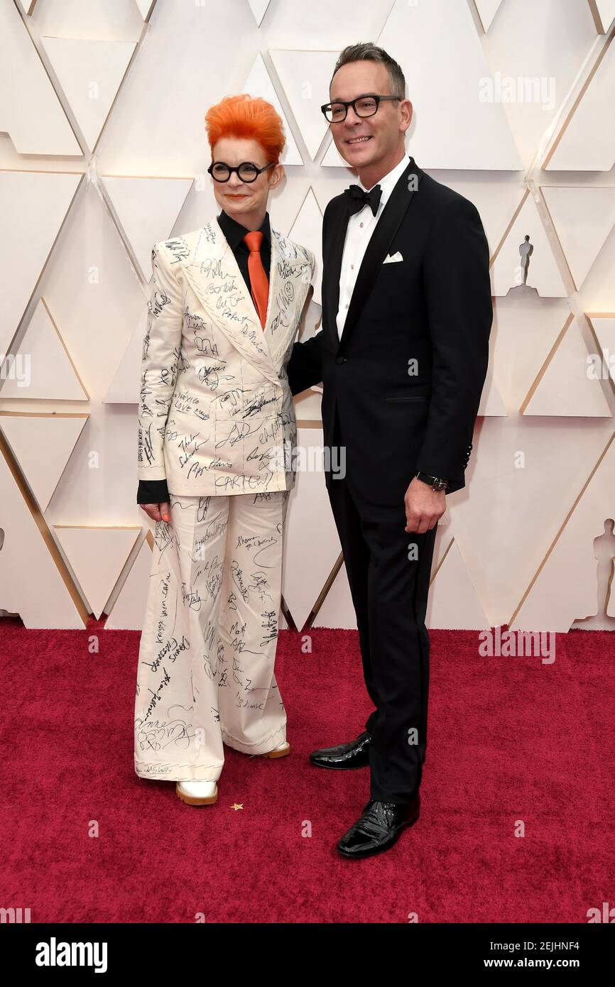 Sandy Powell and Christopher Peterson walking on the red carpet at the ...