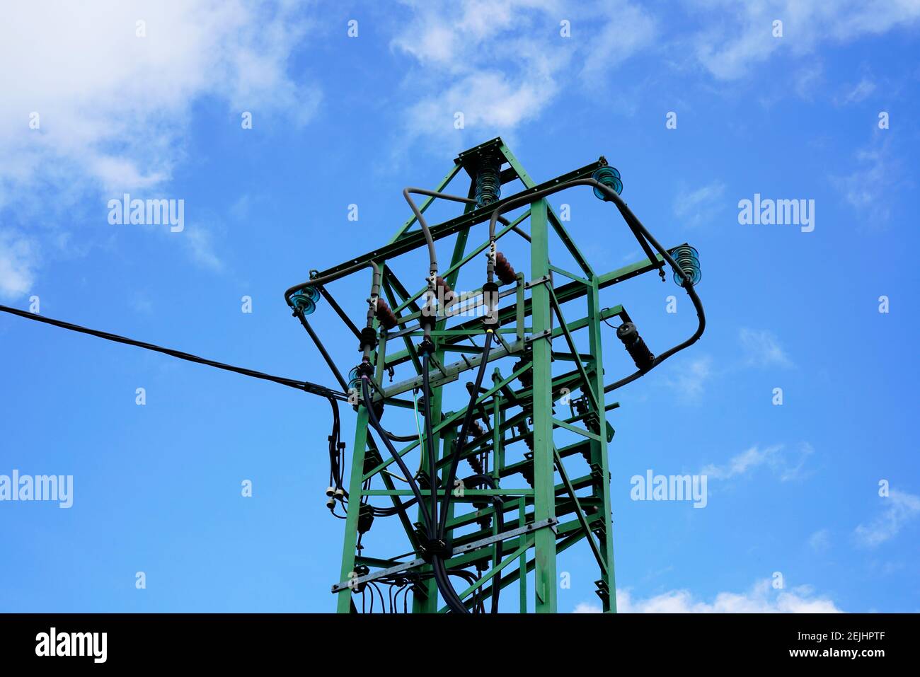 Electricity pole with blue sky and white clouds in the background ...