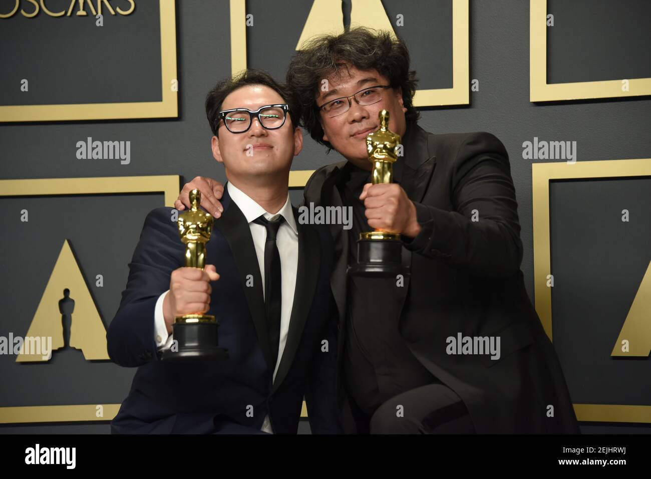 Bong Joon-ho and Han Jin-won, winners of the Original Screenplay award for "Parasite," posing in ...