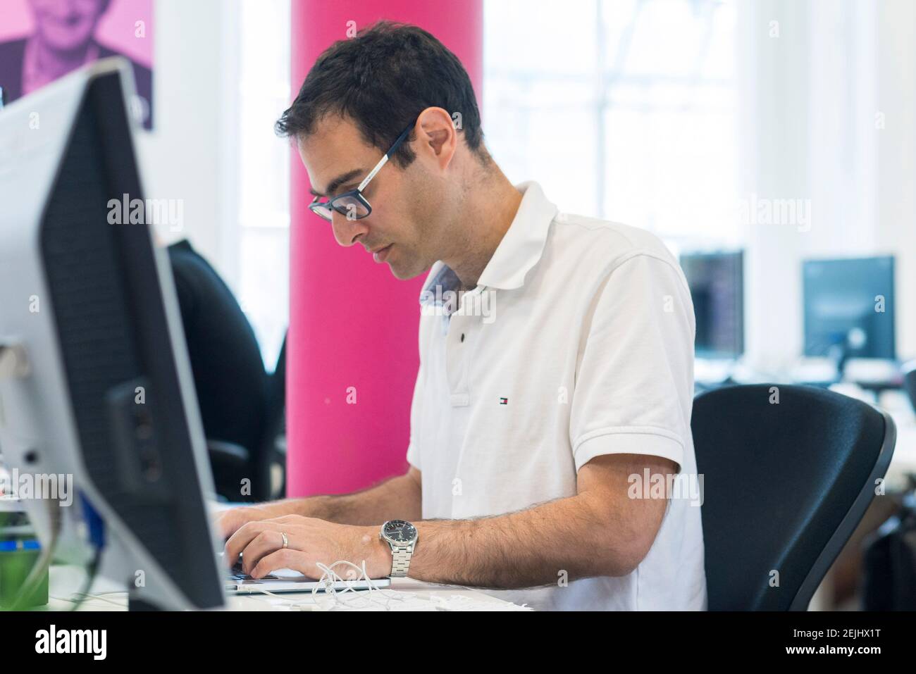 People sat at the work desk in an office and working Stock Photo - Alamy