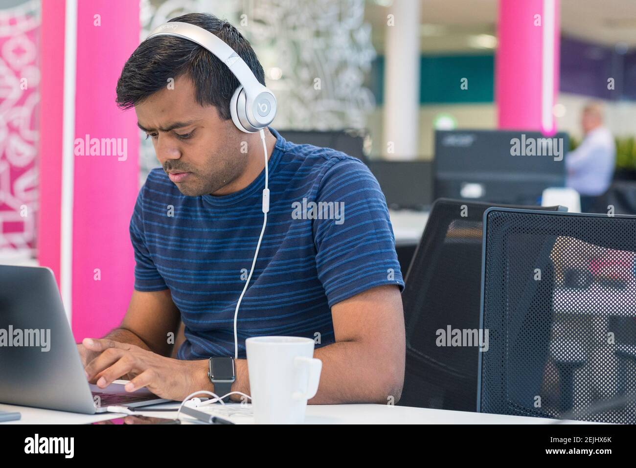 People sat at the work desk in an office and working Stock Photo - Alamy