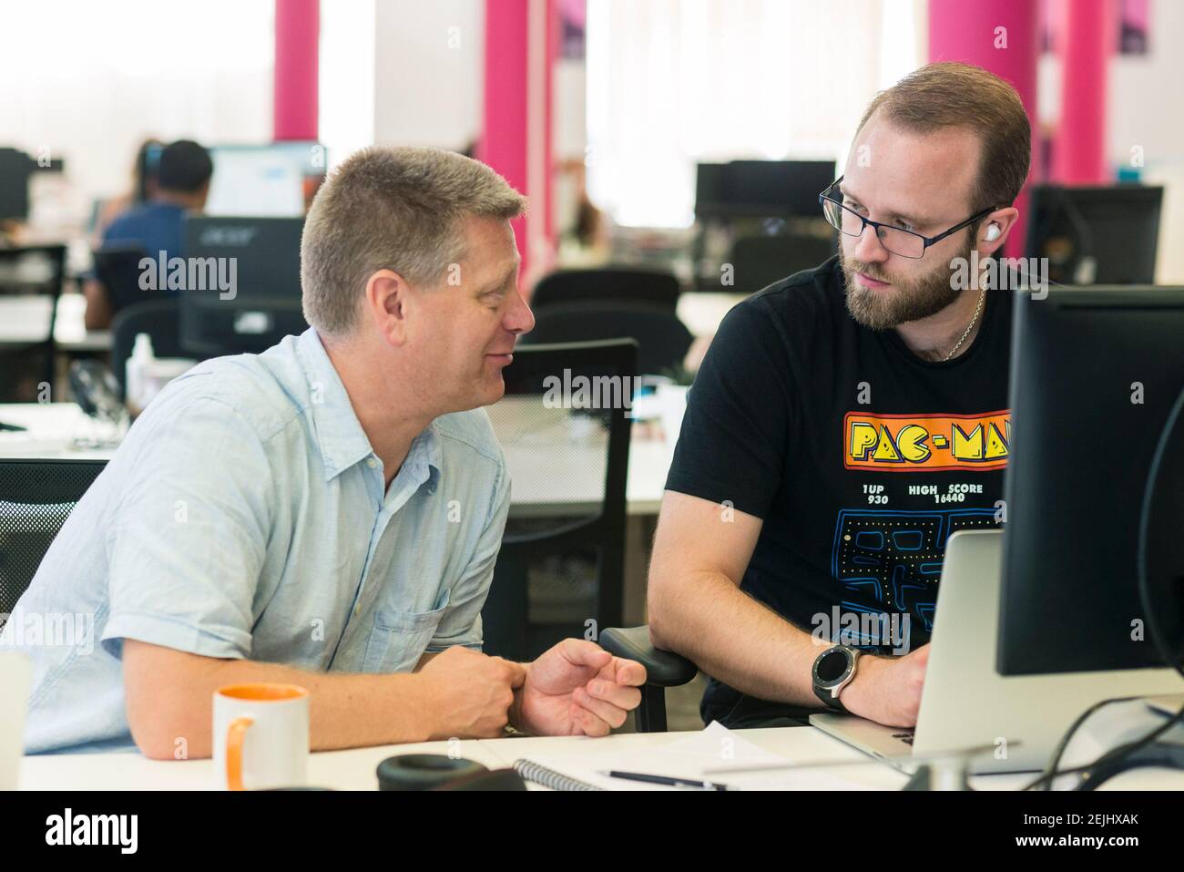 People sat at the work desk in an office and working Stock Photo - Alamy