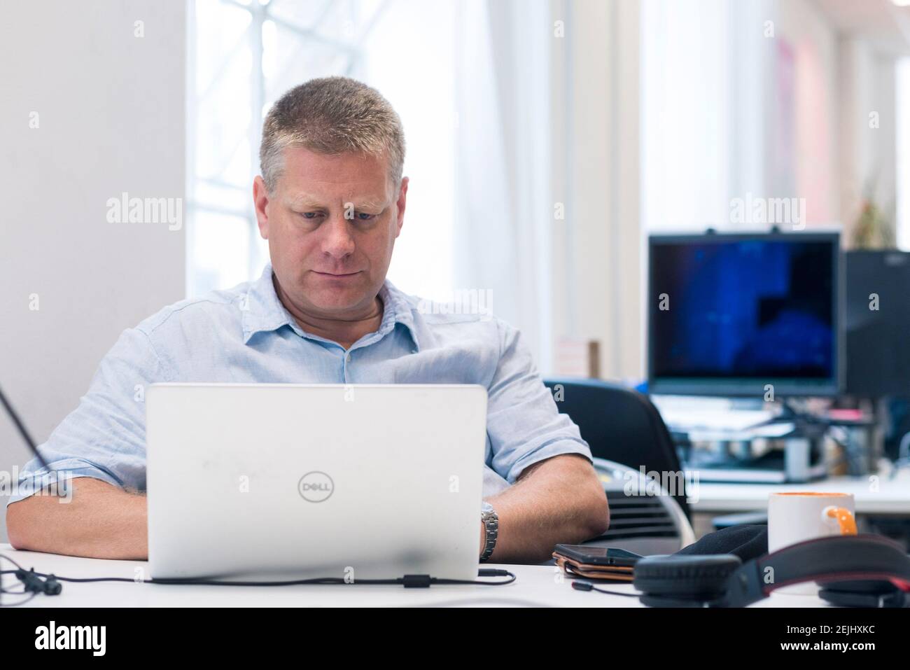People sat at the work desk in an office and working Stock Photo - Alamy