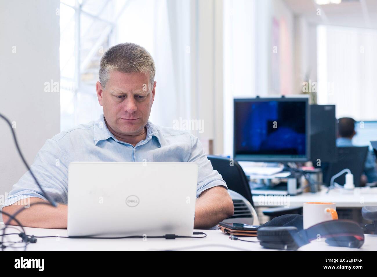 People sat at the work desk in an office and working Stock Photo - Alamy