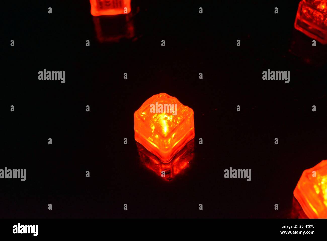Very bright and not ordinary background of red glowing ice cubes ...