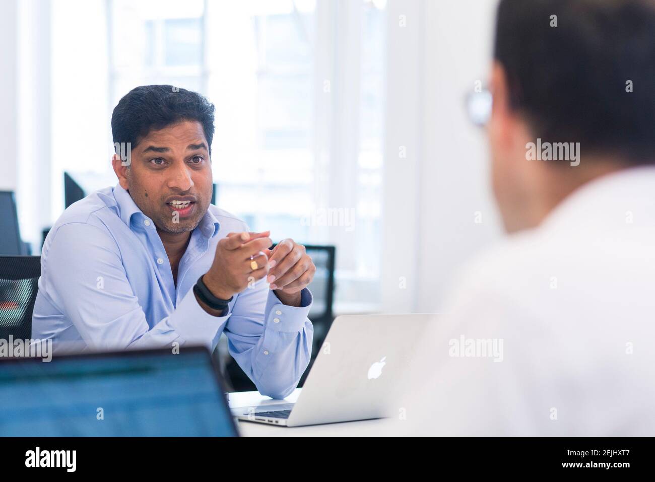People sat at the work desk in an office and working Stock Photo - Alamy