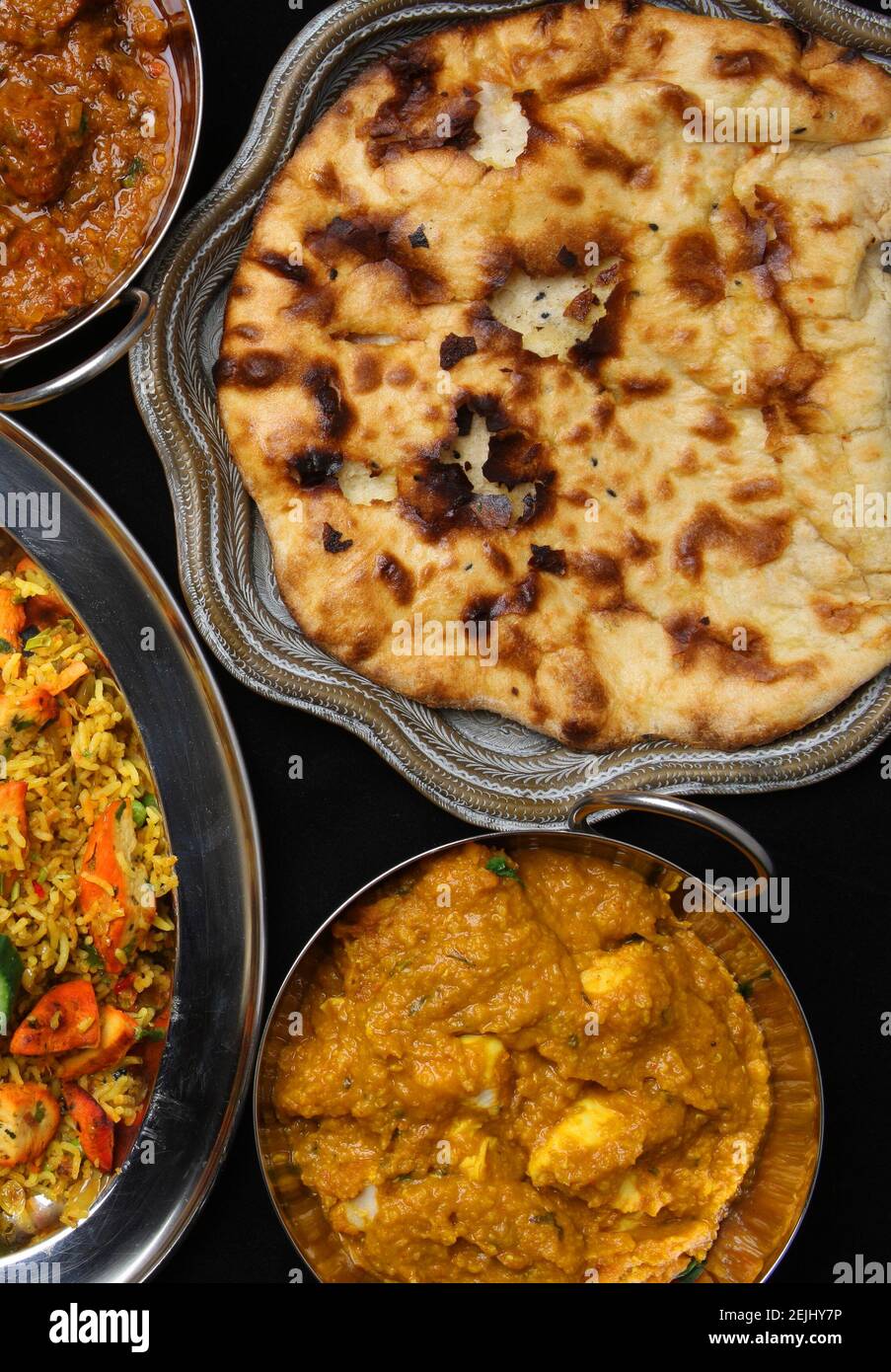 Large naan bread with curry dishes Stock Photo - Alamy